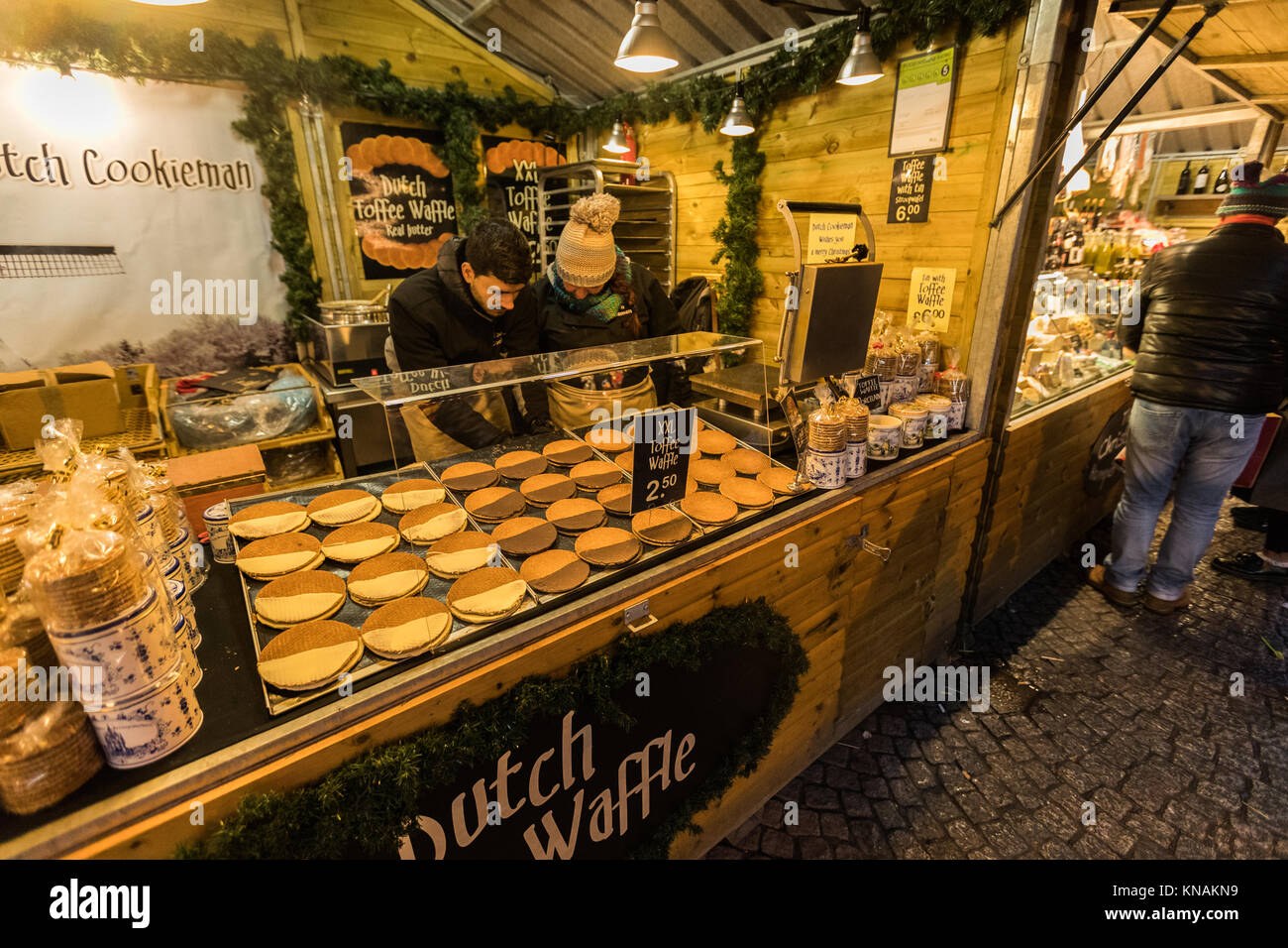 Market stall traders serve food and drink to customers at Manchester ...