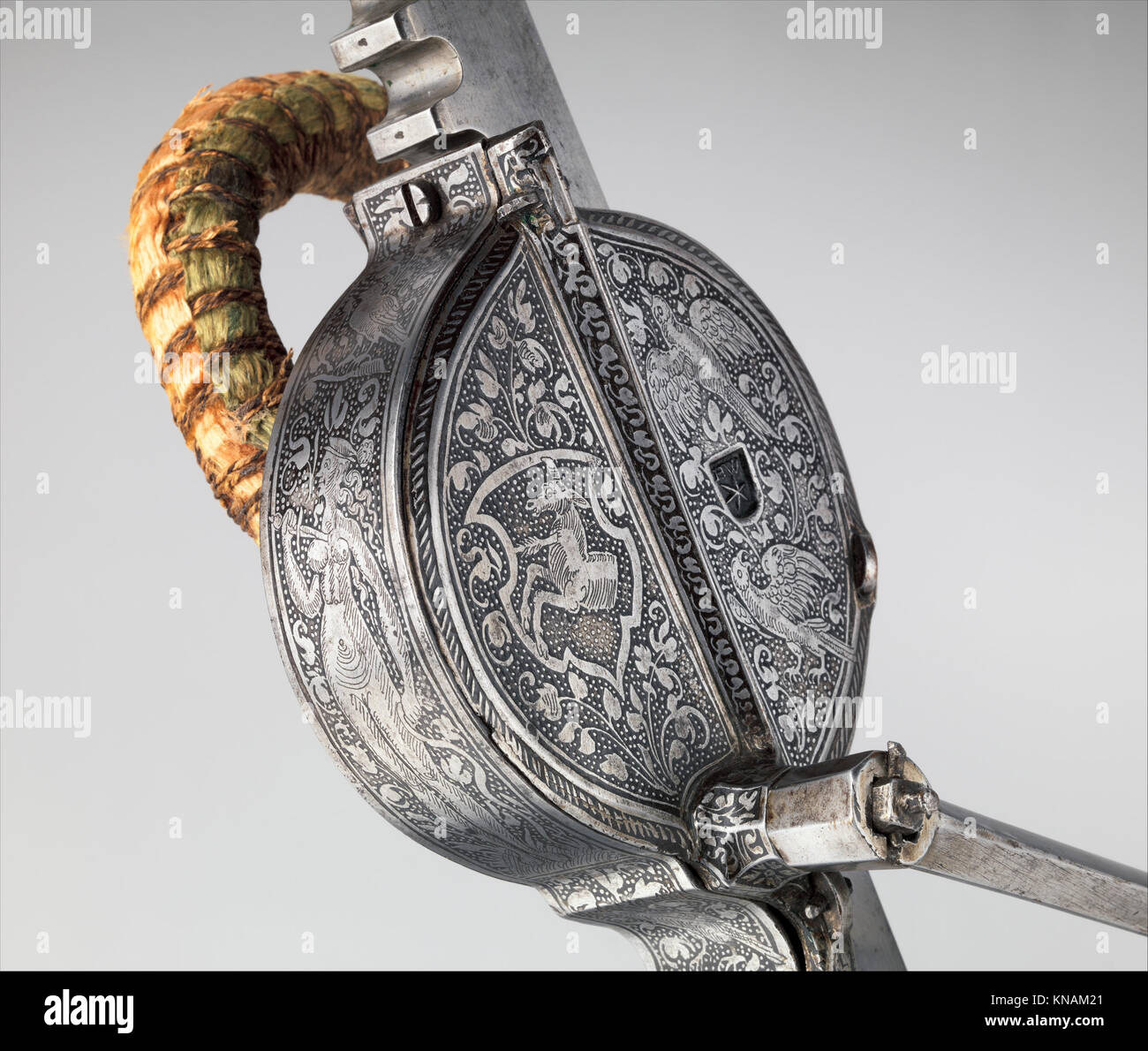 This cranequin, a mechanical device used to draw a crossbow, is part of ...