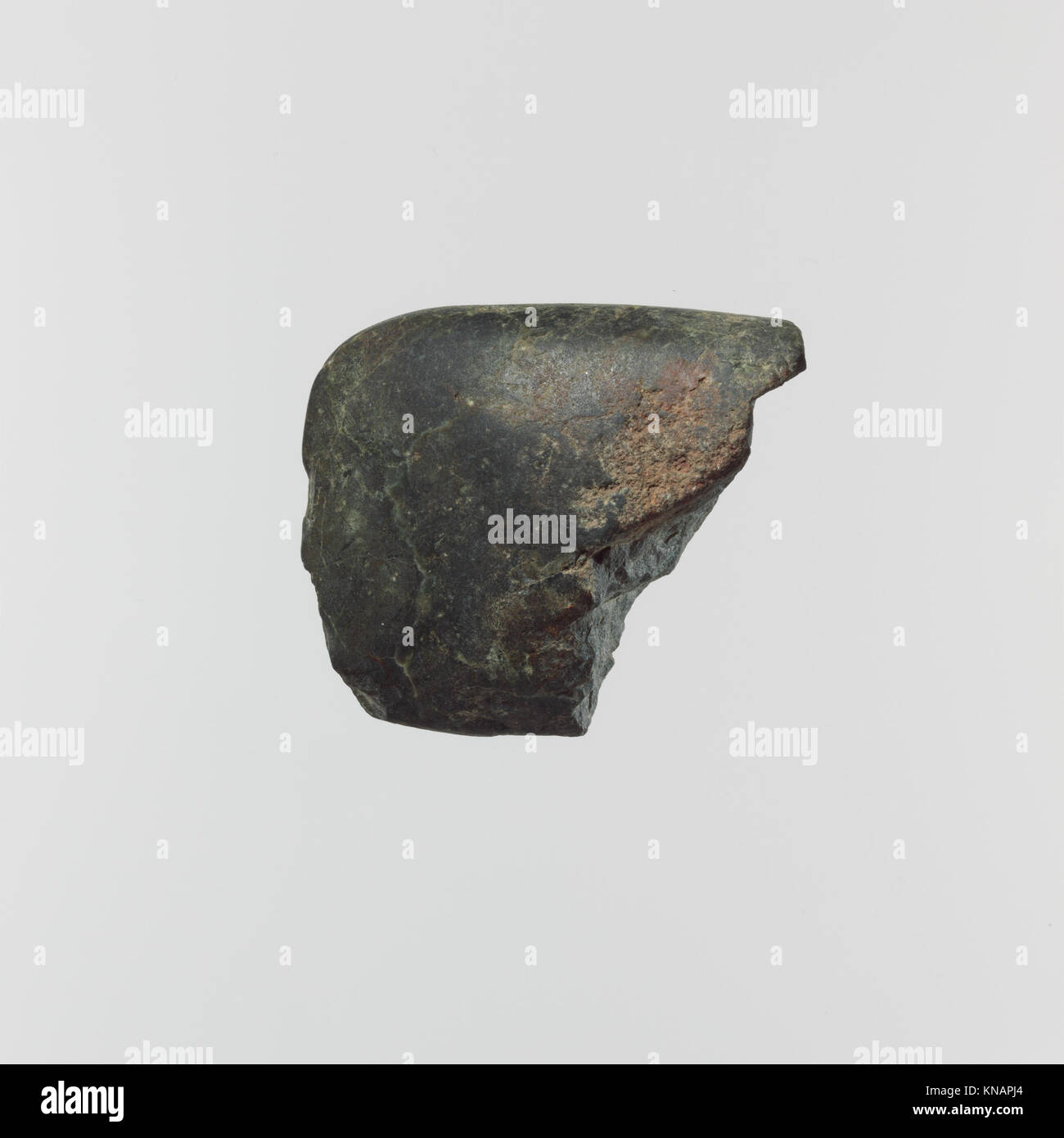 This fragmentary stone axe is an archaeological artifact, illustrating ...