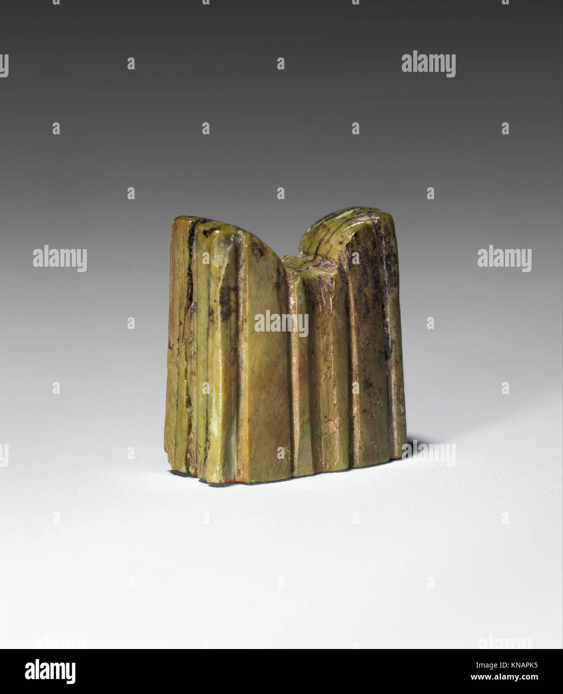 This medieval chess piece, crafted from wood and stone, represents the ...