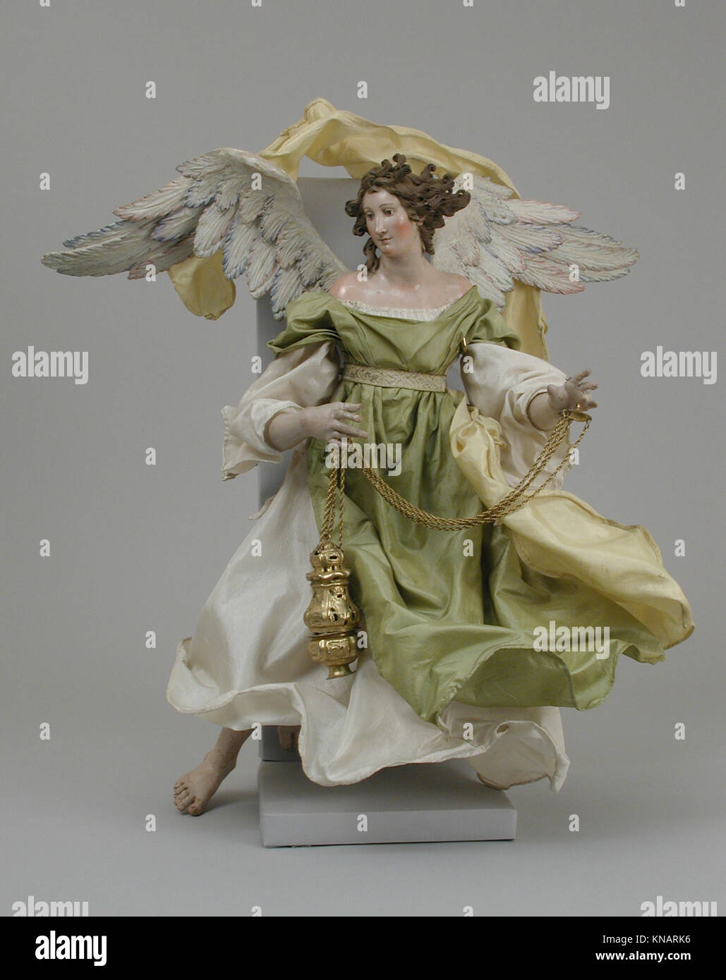 An angel sculpture with detailed wings and facial features represents ...