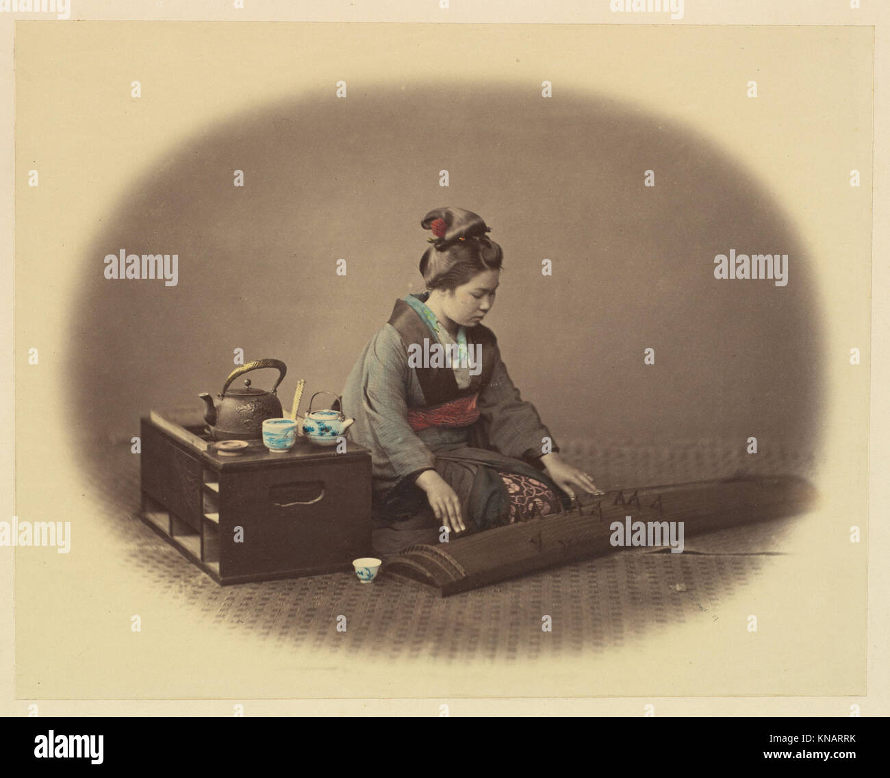 This artwork depicts a woman playing the koto, a traditional Japanese ...