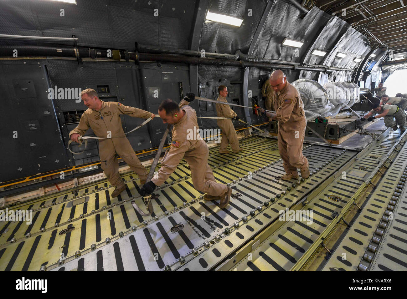 Loadmasters haul a conventional rotary launcher onto a C-5M Supergalaxy ...