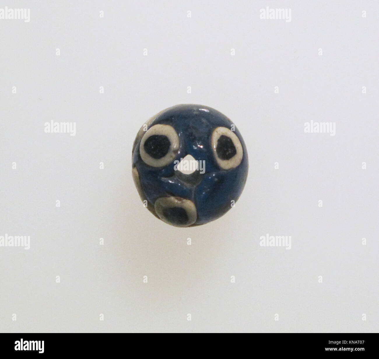 This bead, made from ancient materials, is a decorative and functional ...