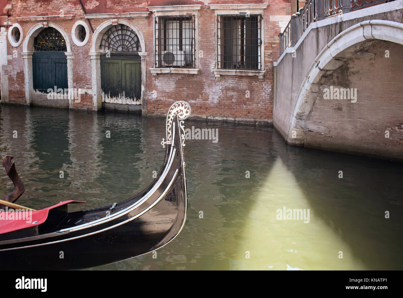 Close up view of gondola's front on a canal with old, historical ...