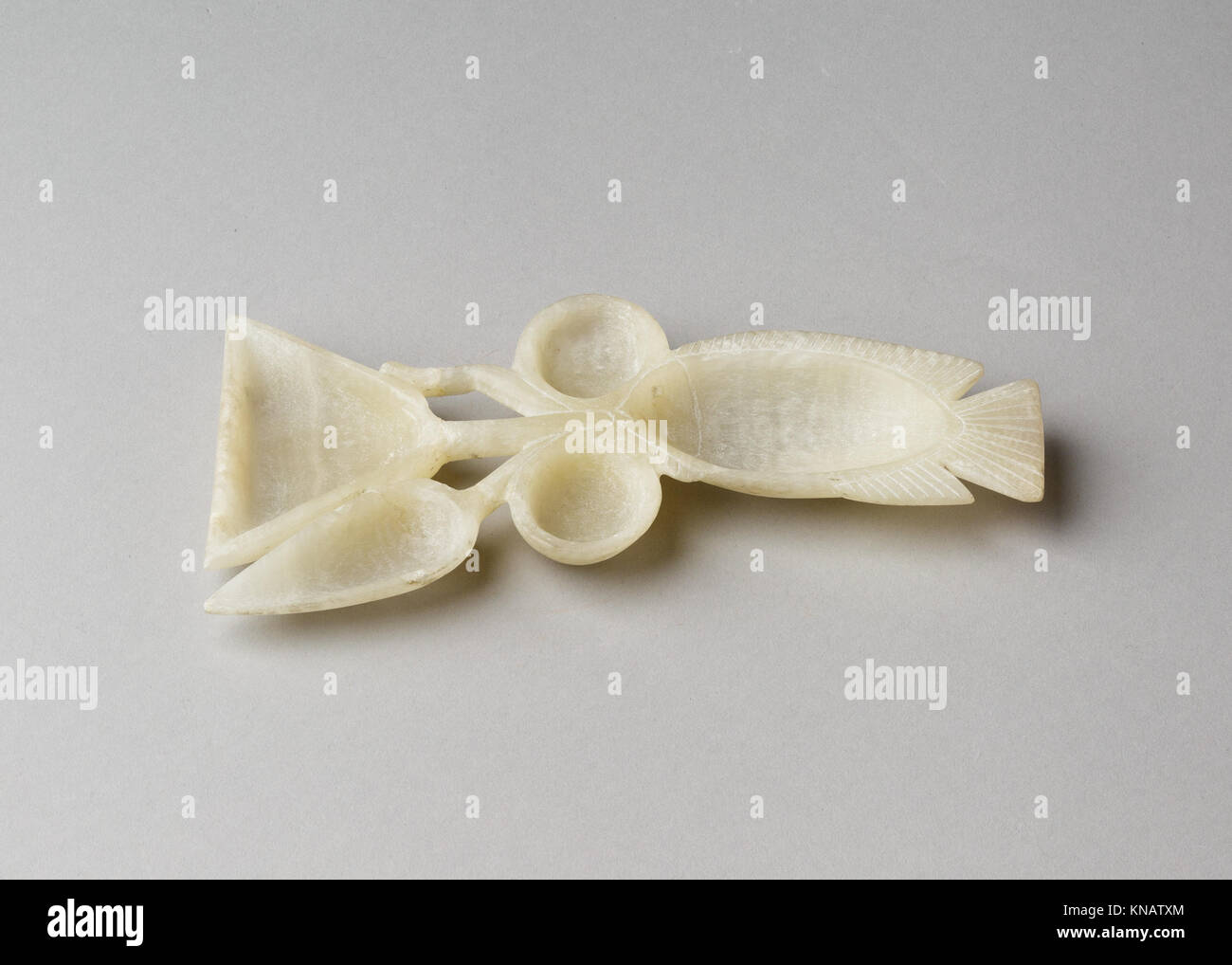 This cosmetic spoon shaped like a tilapia fish, surrounded by water ...
