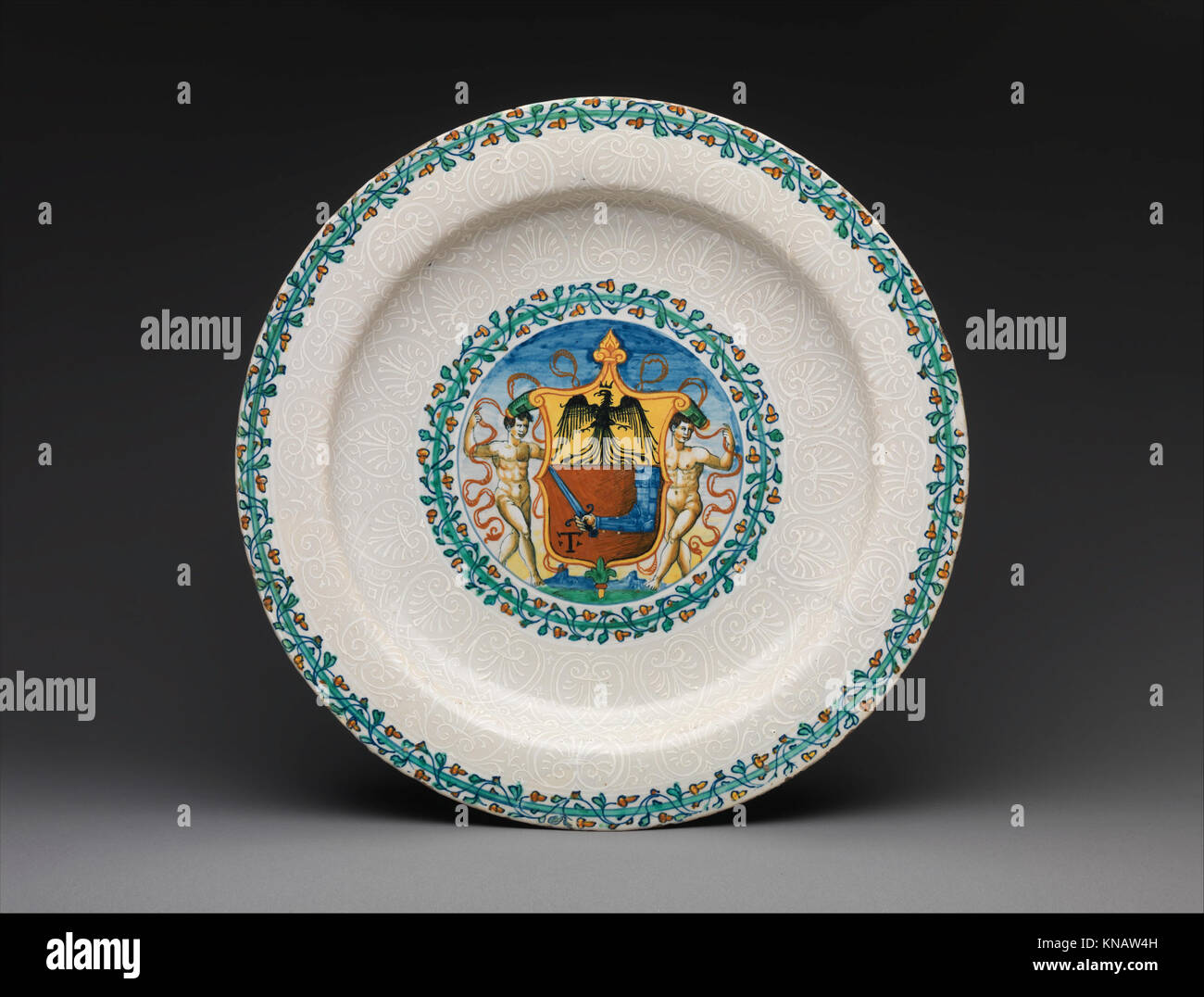 This armorial dish features bianco sopra bianco ornamentation, a ...