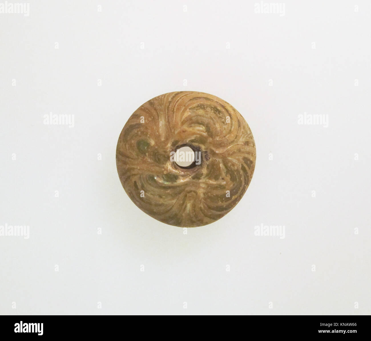 This glass spindle whorl is a preserved example of ancient textile ...