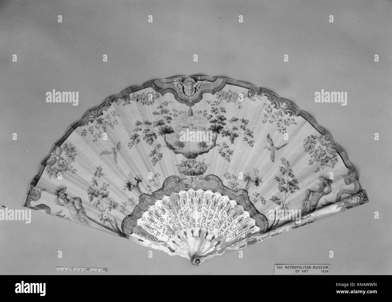 This fan, a decorative and functional item, features intricate design ...