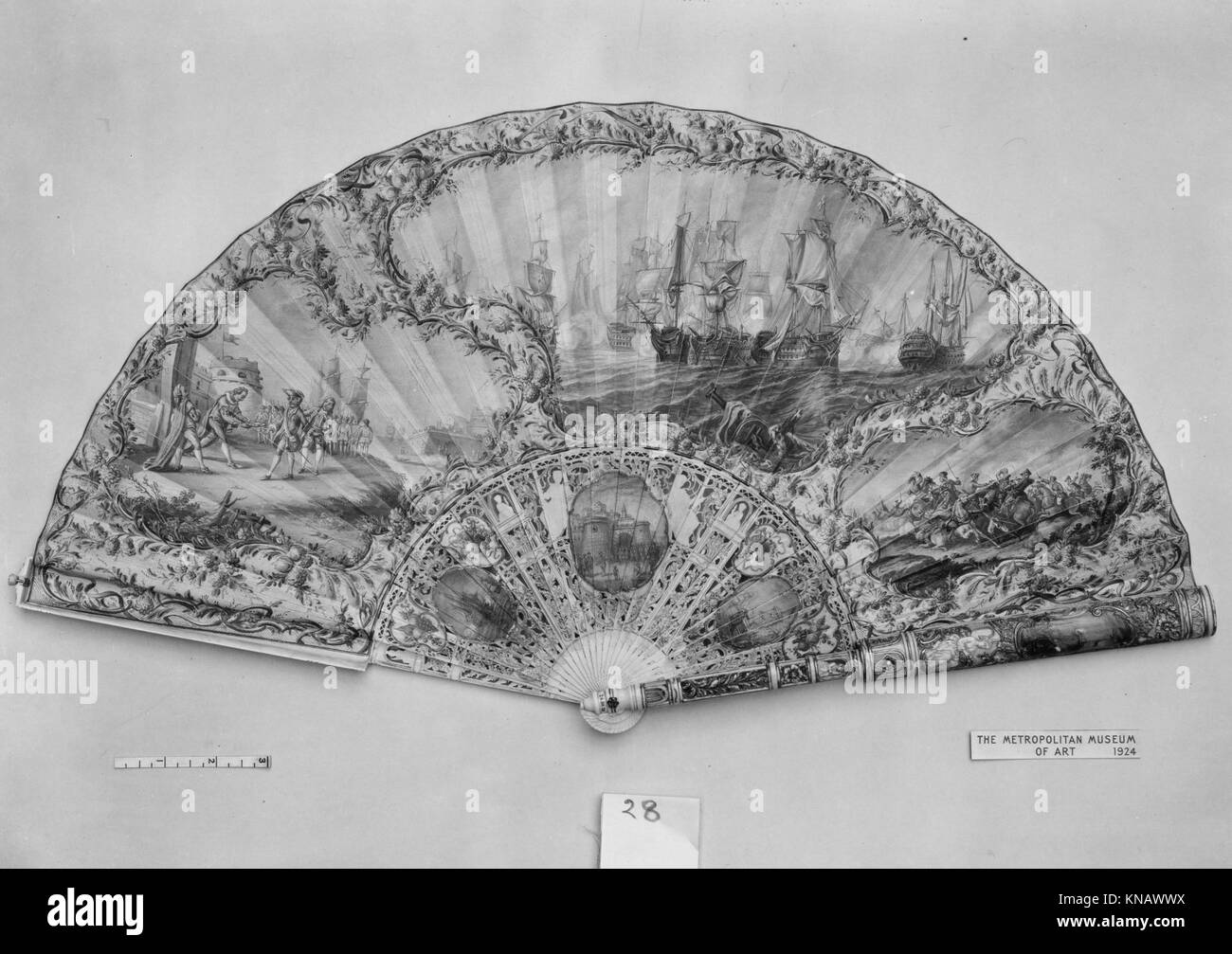 This decorative fan features intricate design work and was likely used ...