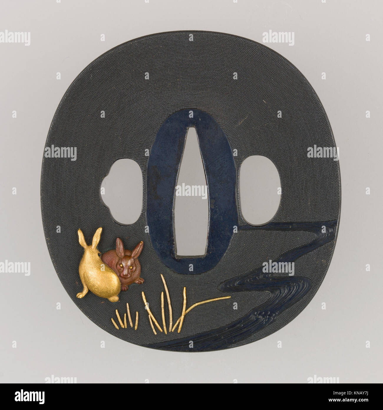 These sword fittings, cataloged as MET 48.63.5b, are part of a pair of ...