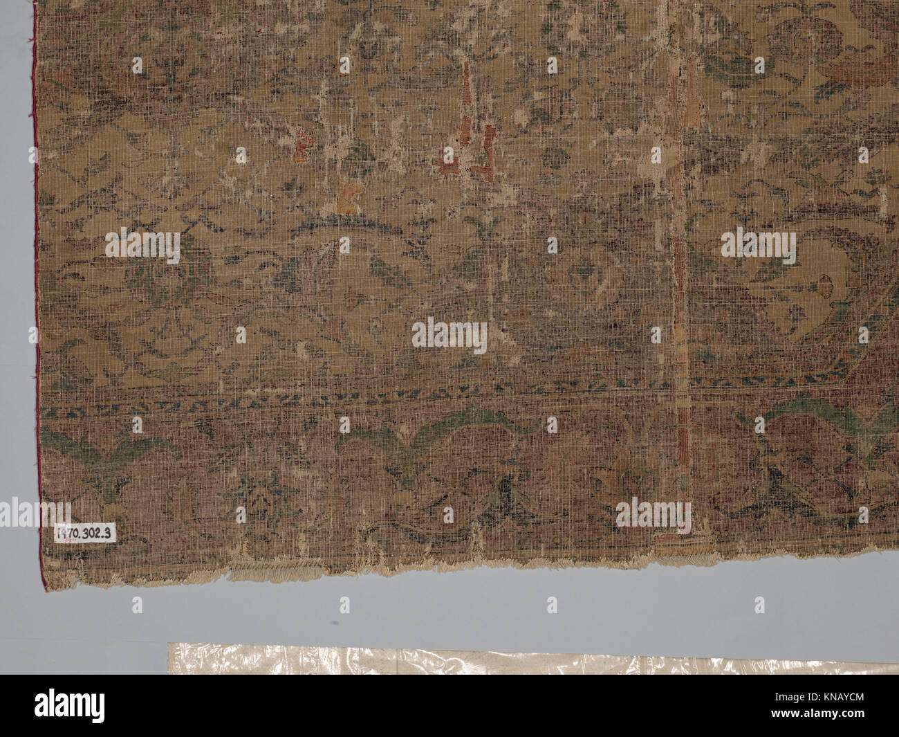 This carpet fragment features intricate weaving patterns, demonstrating ...