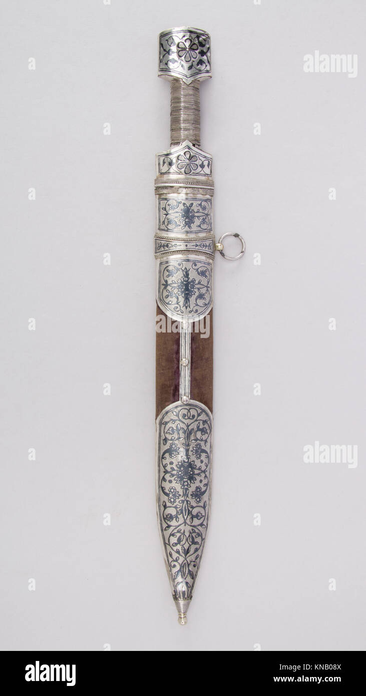 This Qama dagger, featuring a curved blade and a decorative sheath, is ...