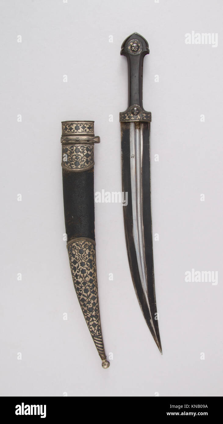 This dagger, paired with a sheath, showcases intricate design and ...