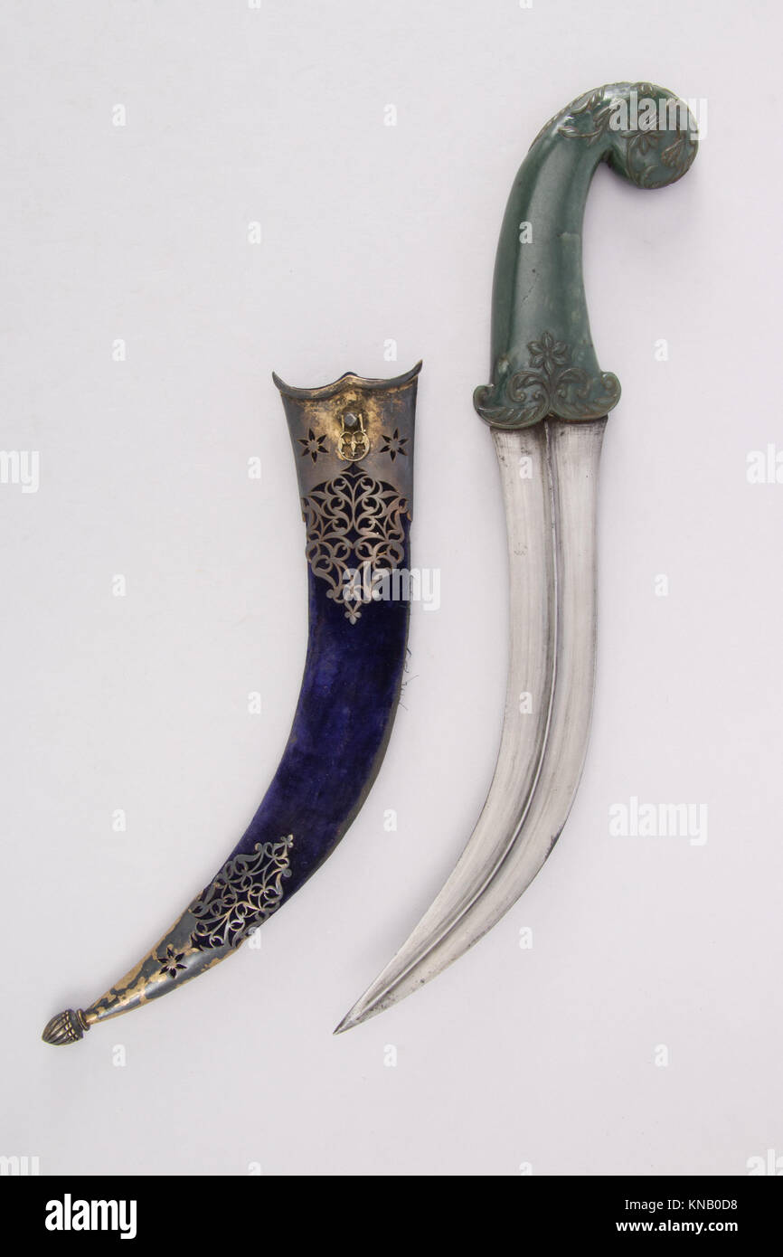 A ceremonial dagger (jambiya) featuring an ornate sheath and a carrier ...
