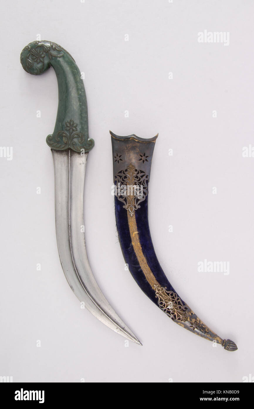 This ornate dagger, known as a jambiya, features a curved blade and ...