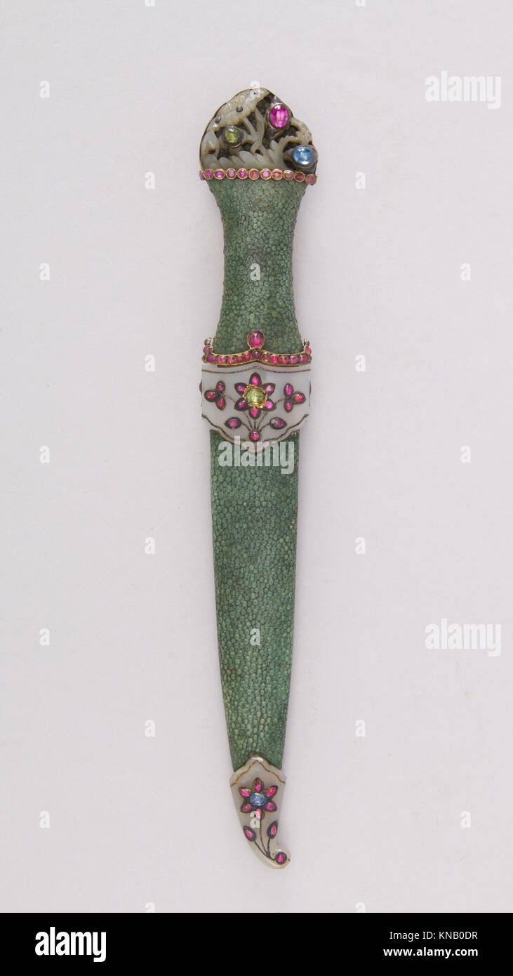 This dagger, accompanied by its sheath, features a detailed design and ...