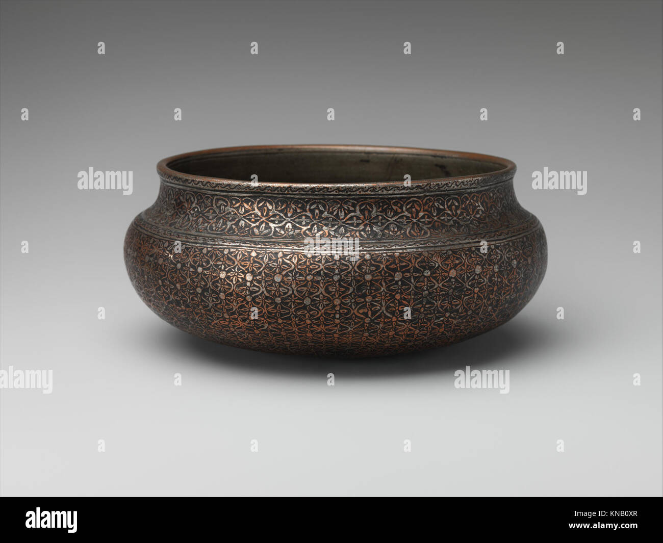 This bowl, originating from the Islamic world, showcases intricate ...