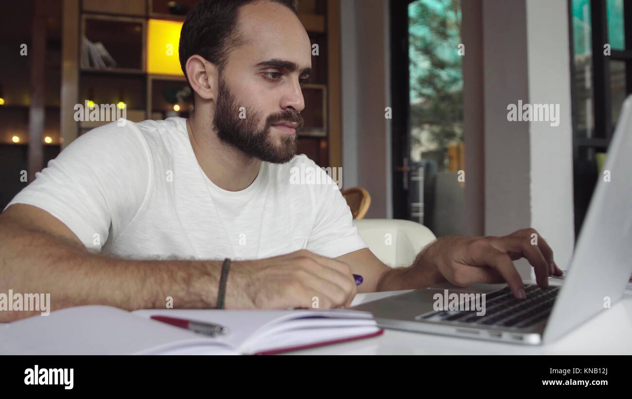 Handsome business man working at laptop computer Stock Photo - Alamy