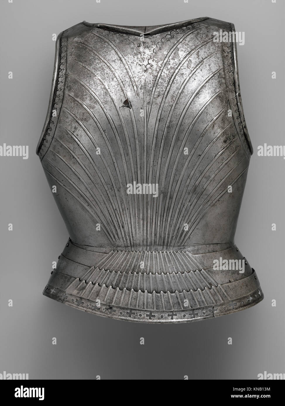 This medieval backplate is part of a suit of armor, offering protection ...