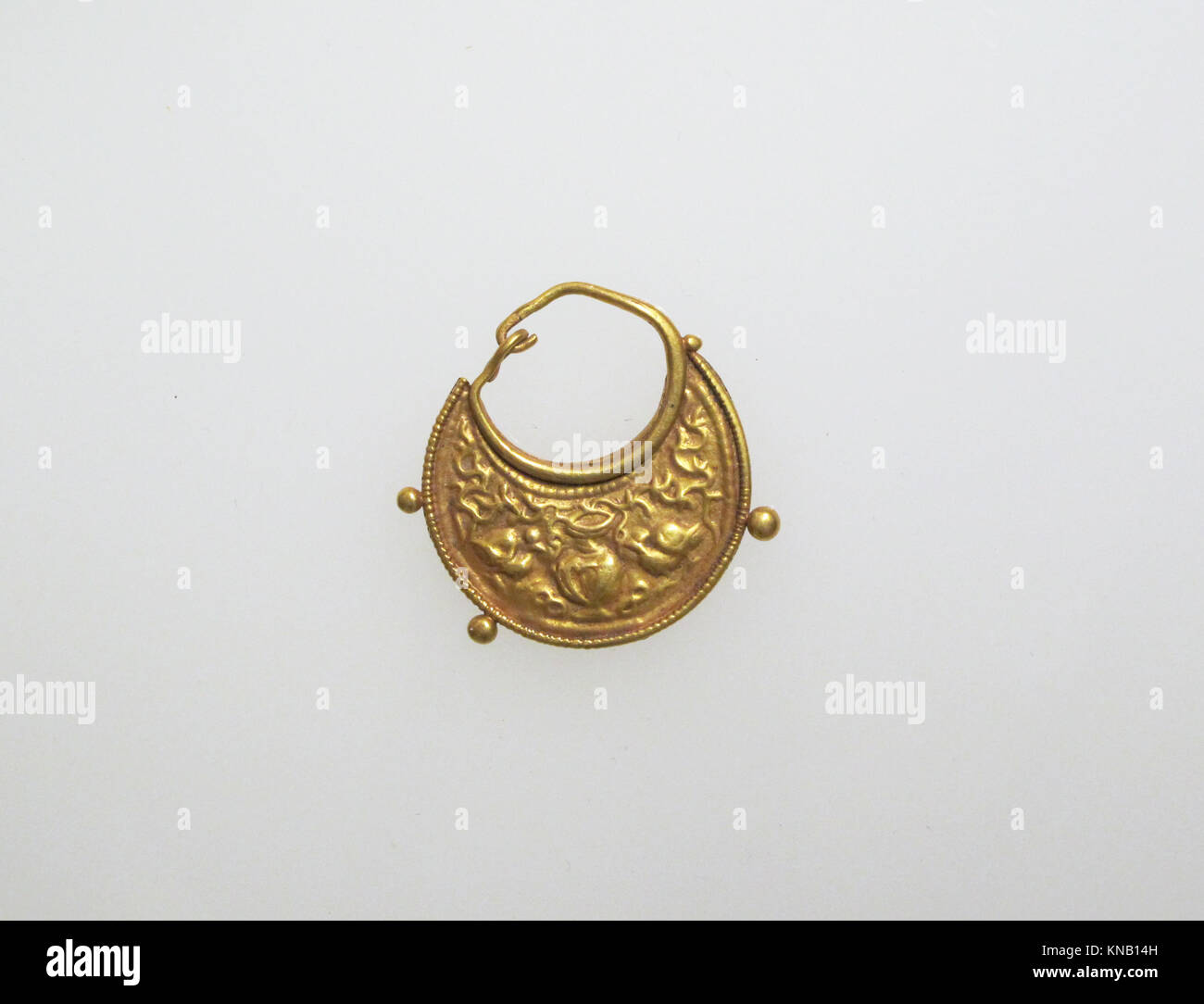 This crescent-shaped earring, part of the MET's collection ...