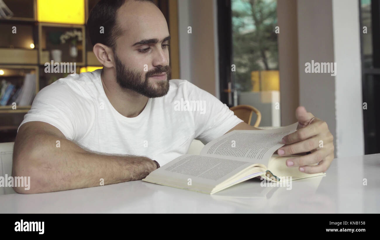 Man reading interesting book Stock Photo - Alamy