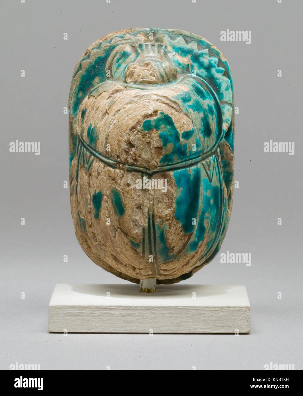 This scarab of Amenhotep III, made from stone, depicts a lion hunt and ...