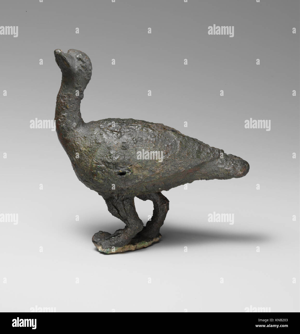 This bronze statuette depicts a goose, crafted with precision to ...