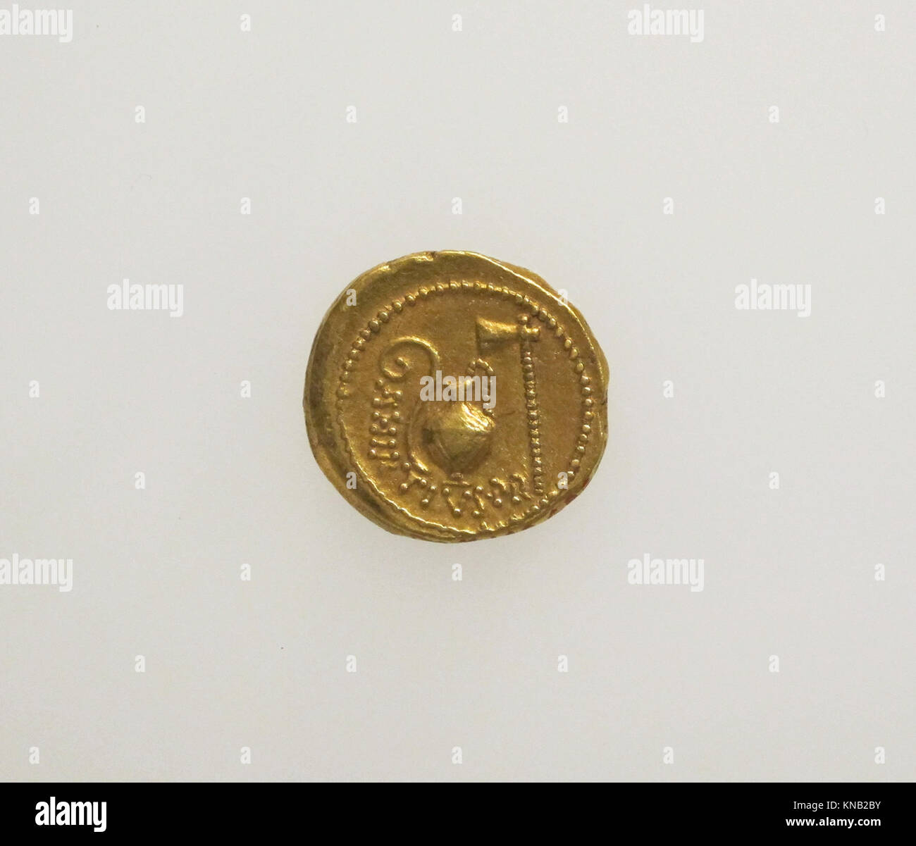 A gold aureus coin featuring the image of Julius Caesar, displayed at ...