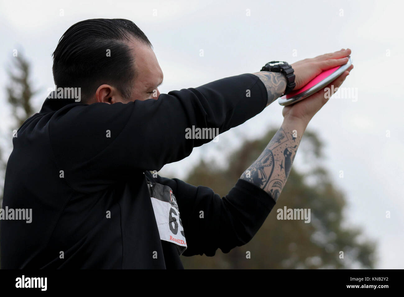 U.S. Army Sgt. Mario Felix winds up to throw a discus during the field ...