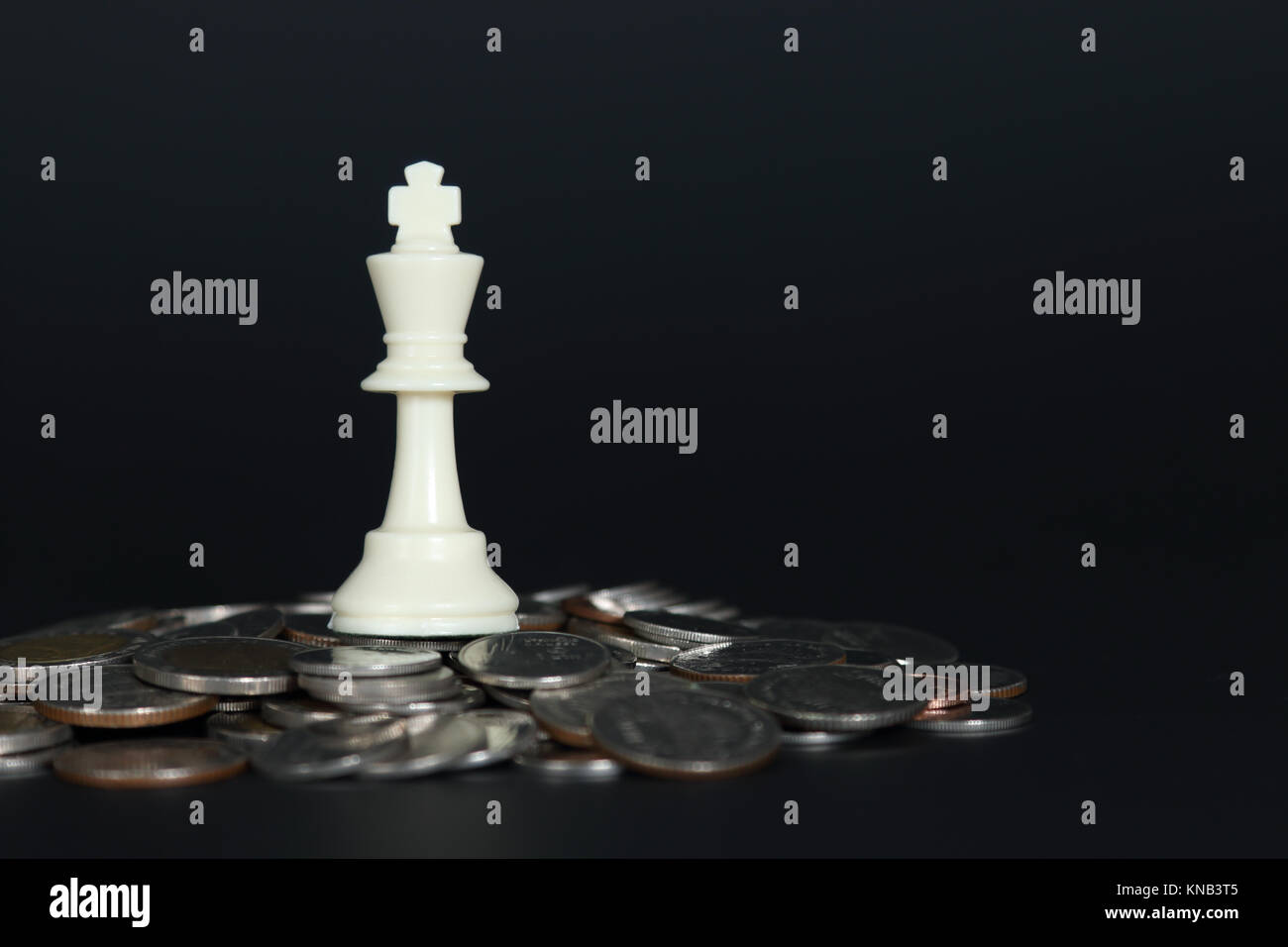 Chess king on coins. Business concept Stock Photo - Alamy