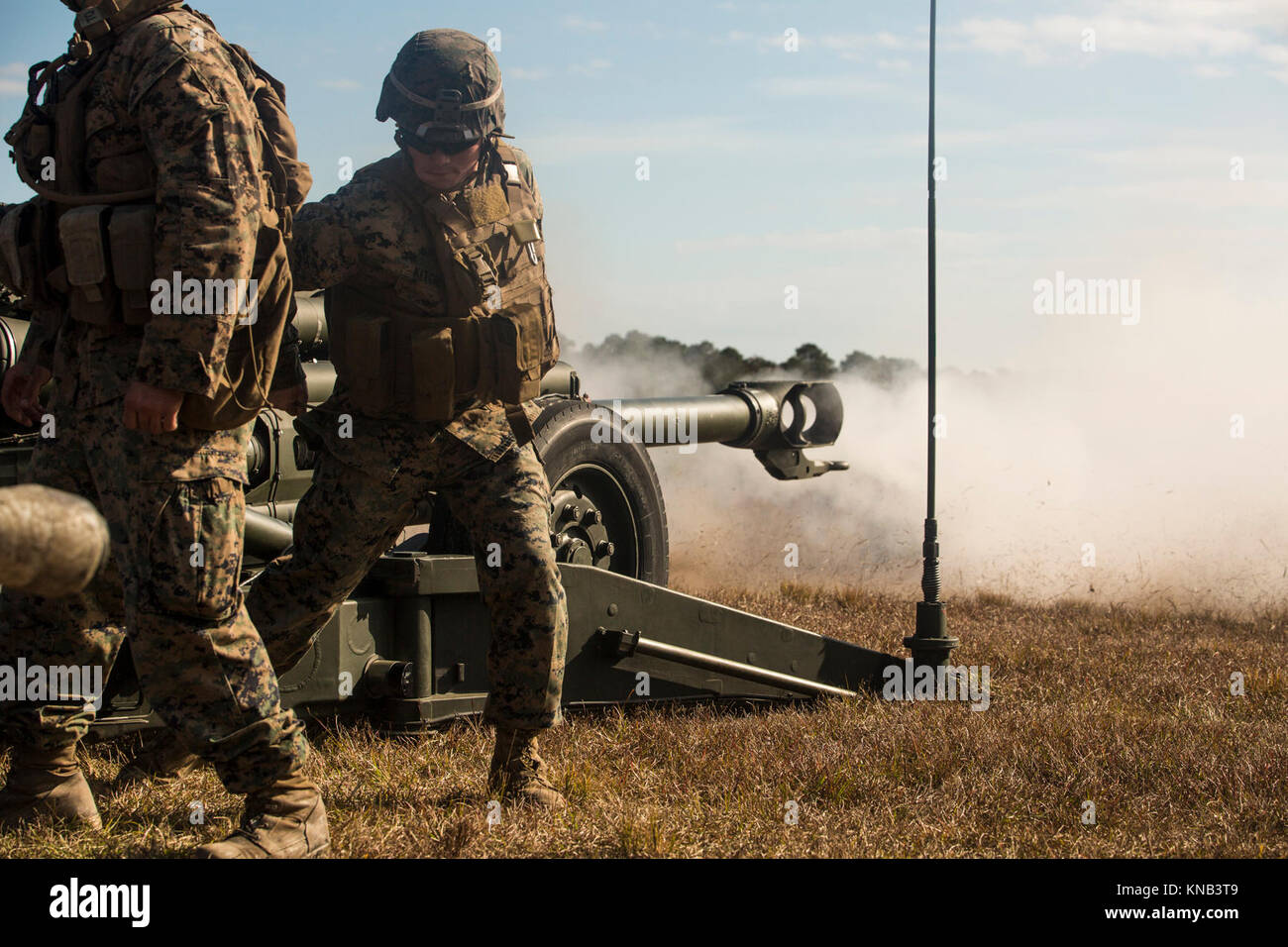 A Marine pulls the cord to fire an M777 A2 howitzer during a direct ...