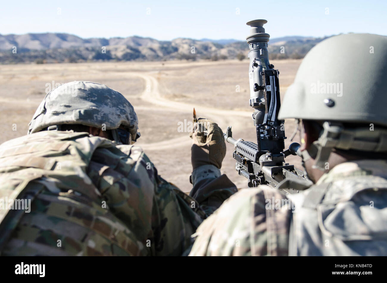U.S. Army Reserve Pfc. Ricardo Ramirez prepares to load a round into an ...
