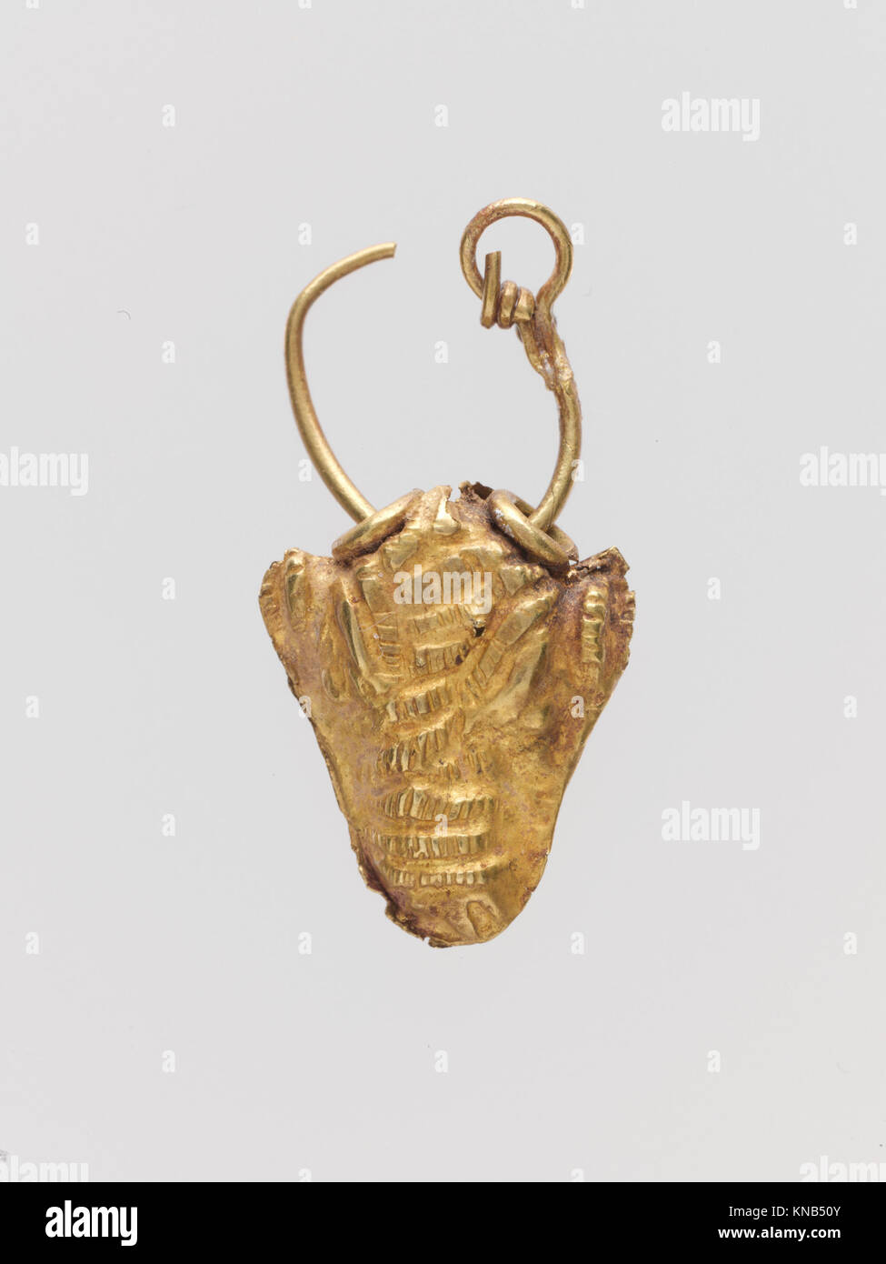 This gold pendant is designed in the form of a bull's head. It reflects ...