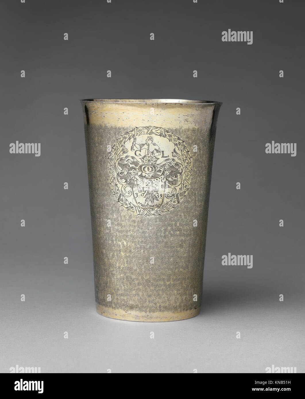 This beaker, crafted from glass, is an ancient artifact that showcases ...