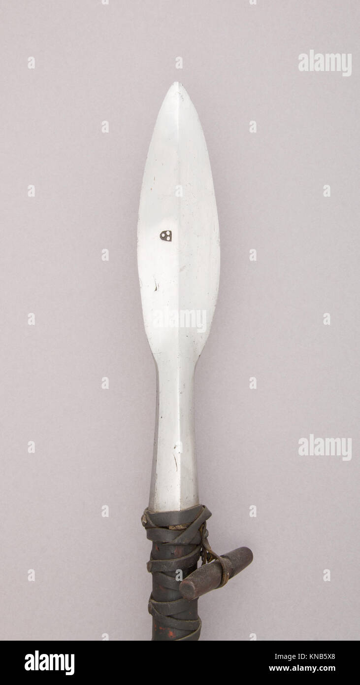 A boar spear with a broad, leaf-shaped blade and a wooden shaft. The ...