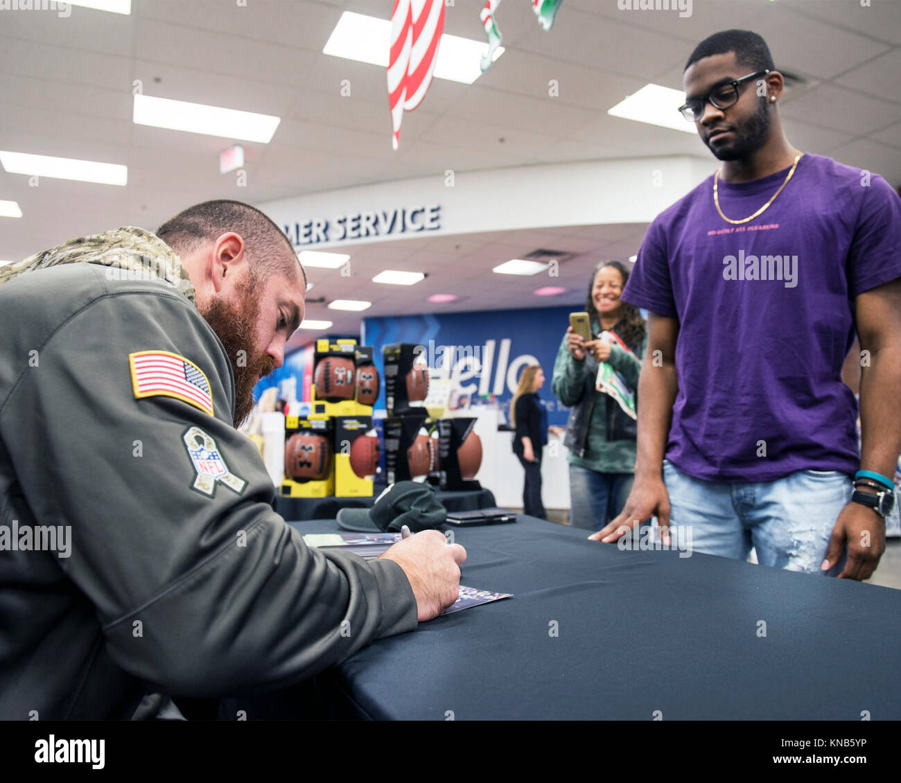 Oakland Raiders tight end Lee Smith signs an autograph for a fan during ...