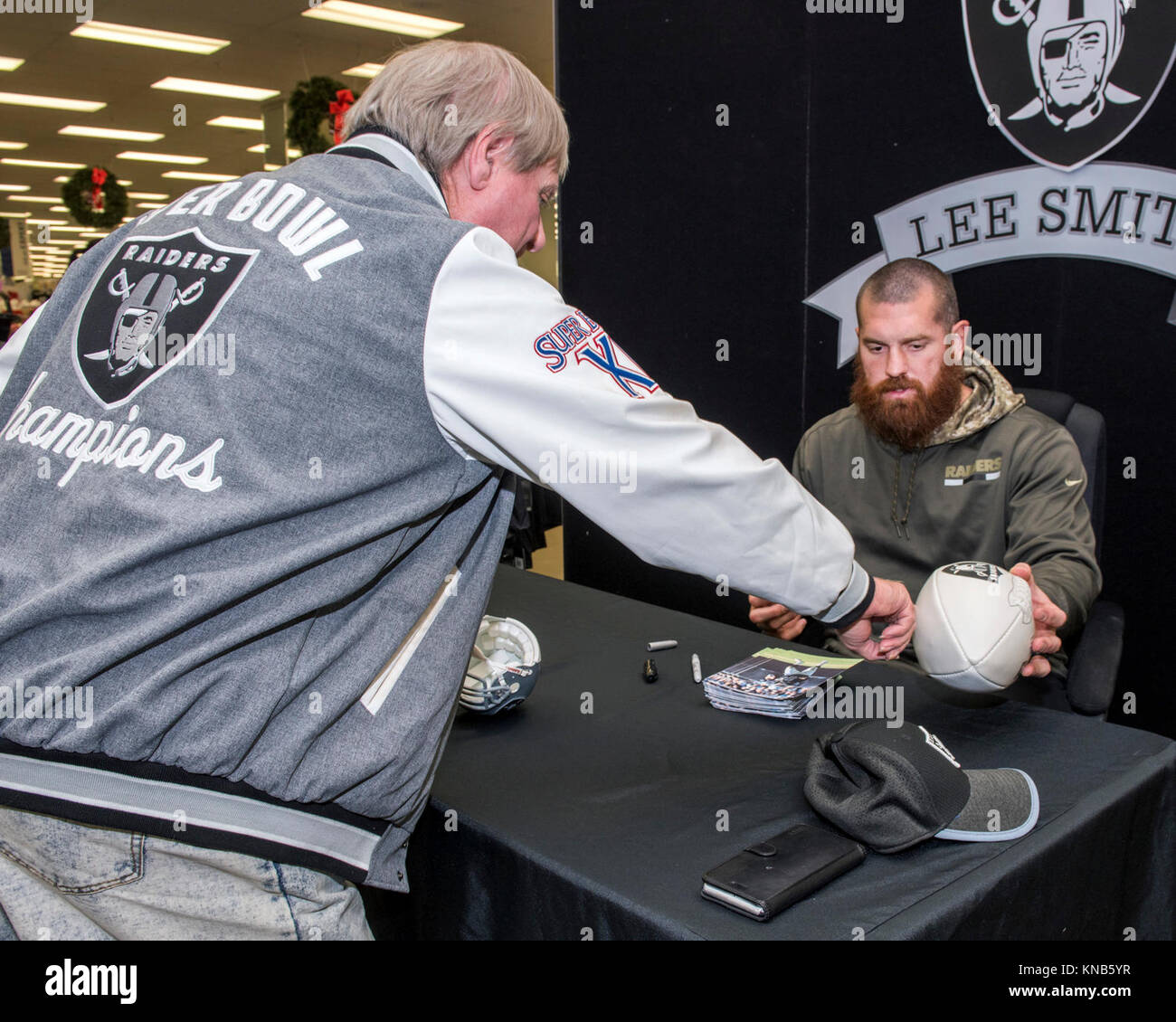 Oakland Raiders tight end Lee Smith signs an autograph for a fan during ...