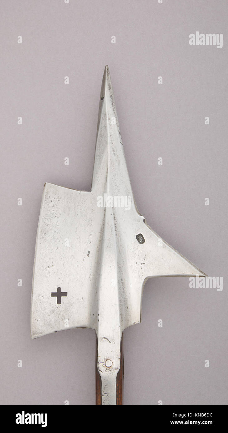 This halberd, a medieval pole weapon, combines an axe blade, spearpoint ...