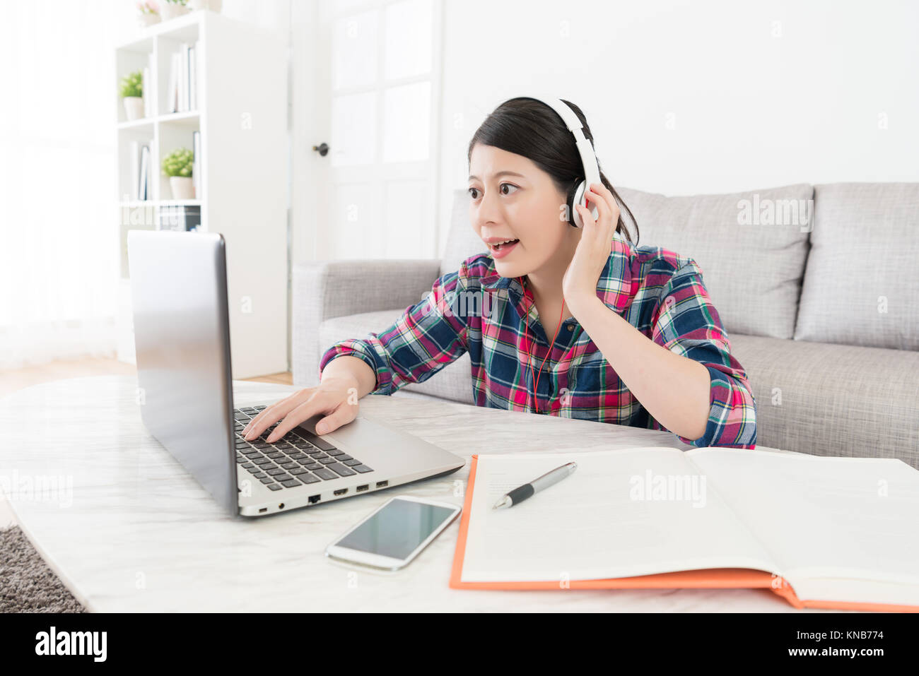 elegant lovely woman doing homework in living room and using mobile ...