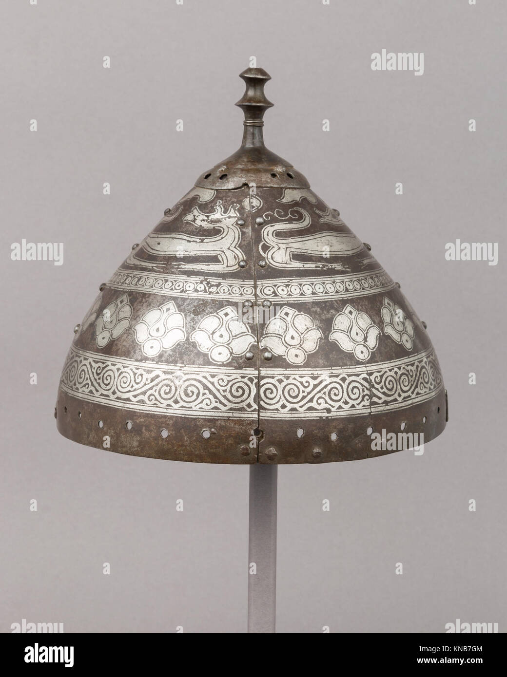 This helmet is a historical example of protective headgear, showcasing ...