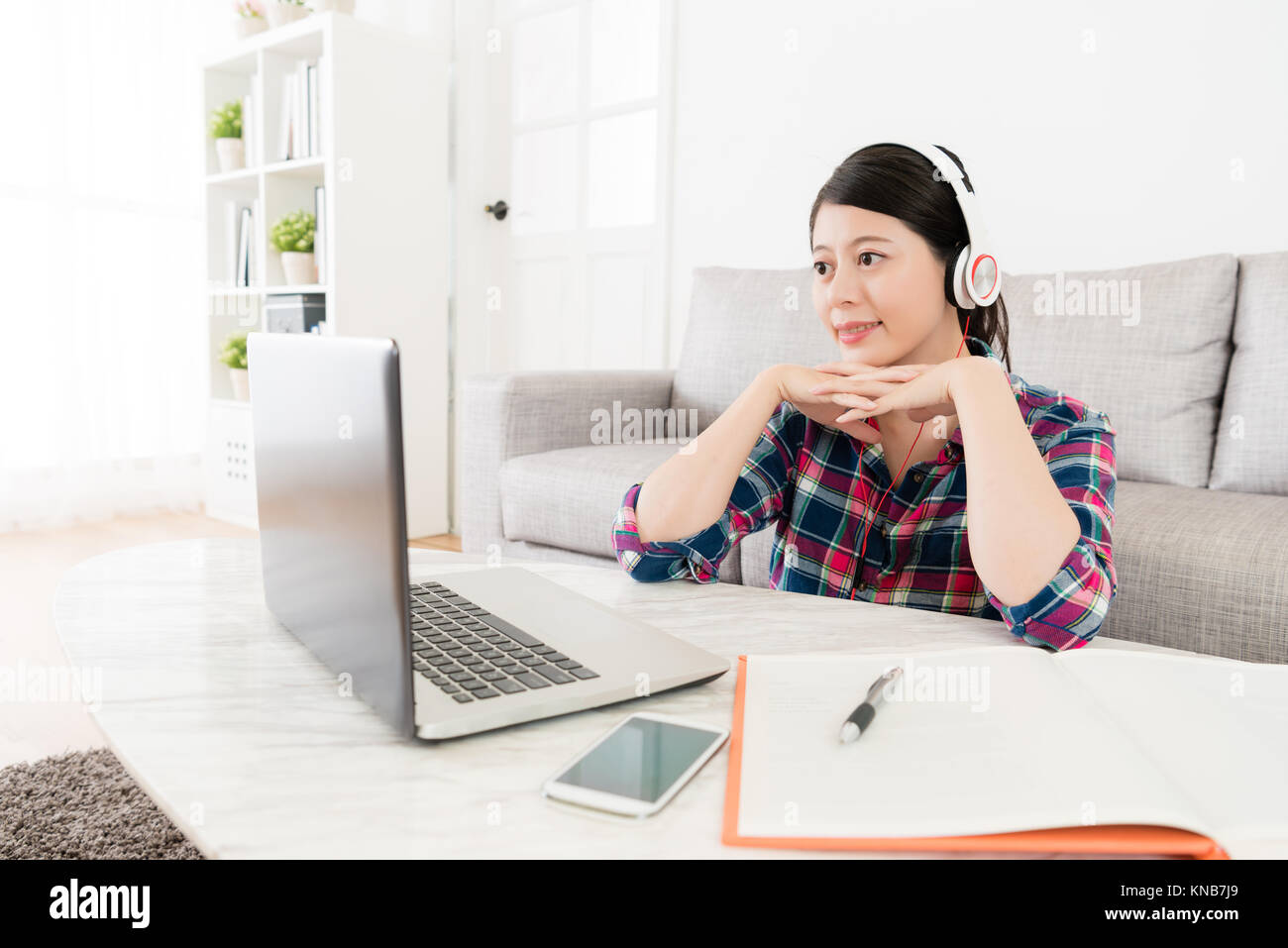 elegant smiling female student watching online e-learning system ...