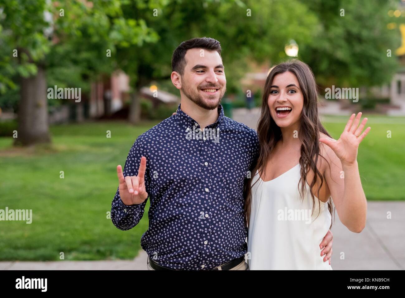 Two college students being funny for the camera during their graduation ...