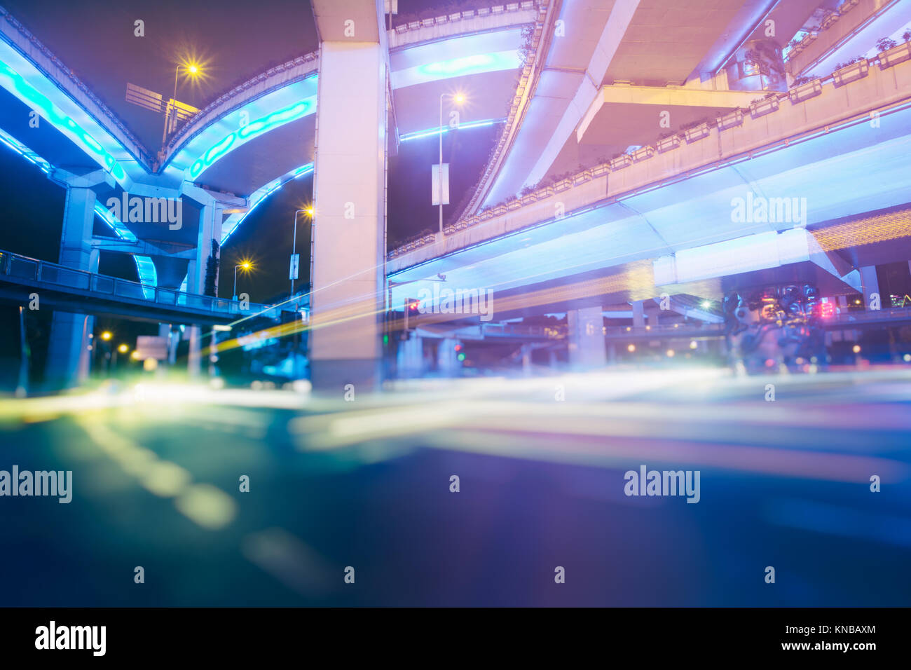 blurred traffic lights on road in central district at night Stock Photo ...