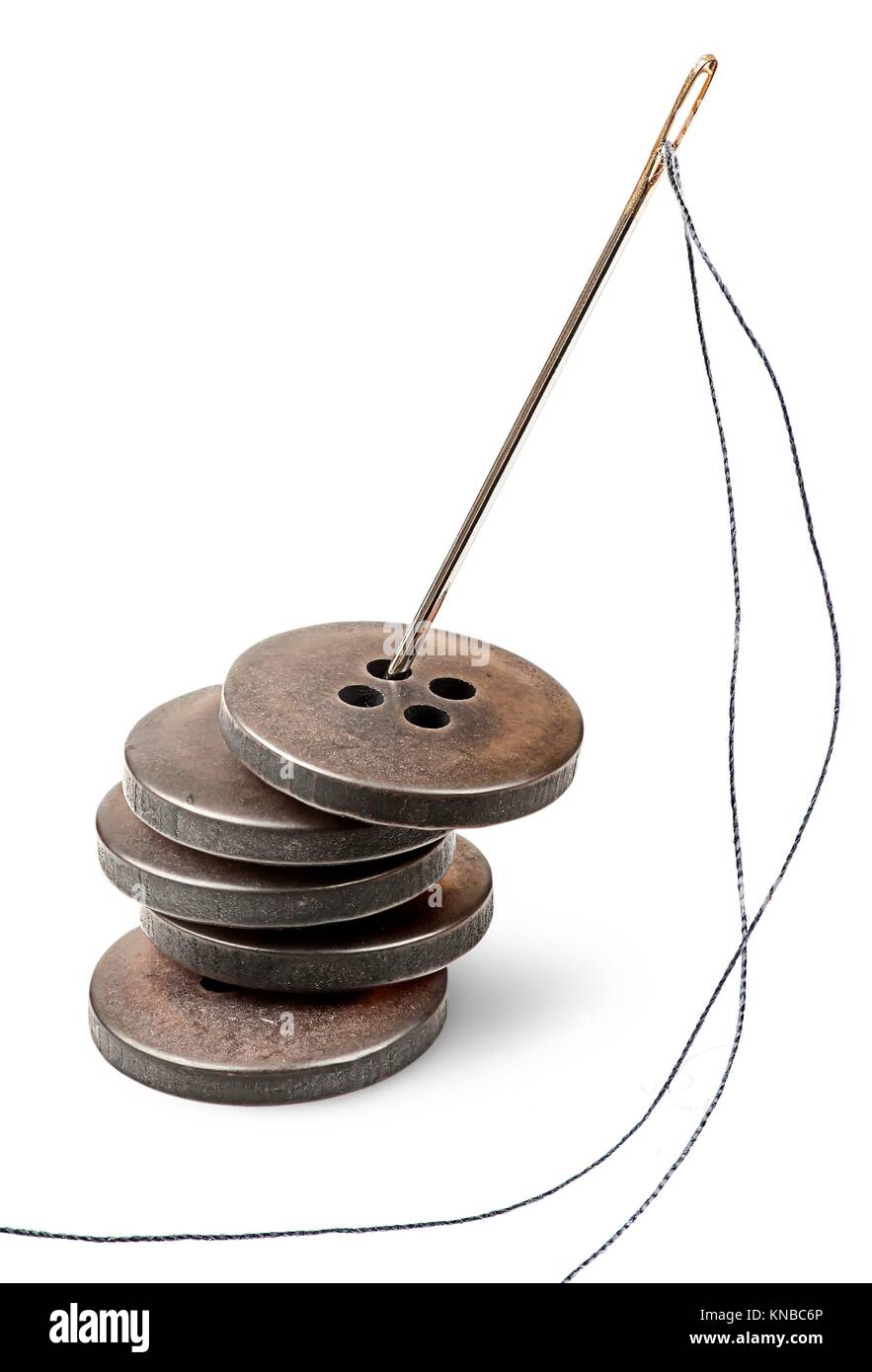 Stack of old buttons and needle with thread isolated on white ...