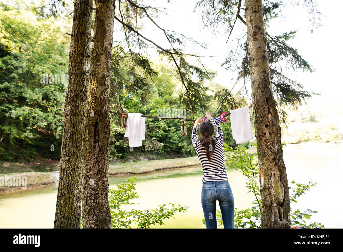 Woman on camping holiday in forest at the lake Stock Photo - Alamy