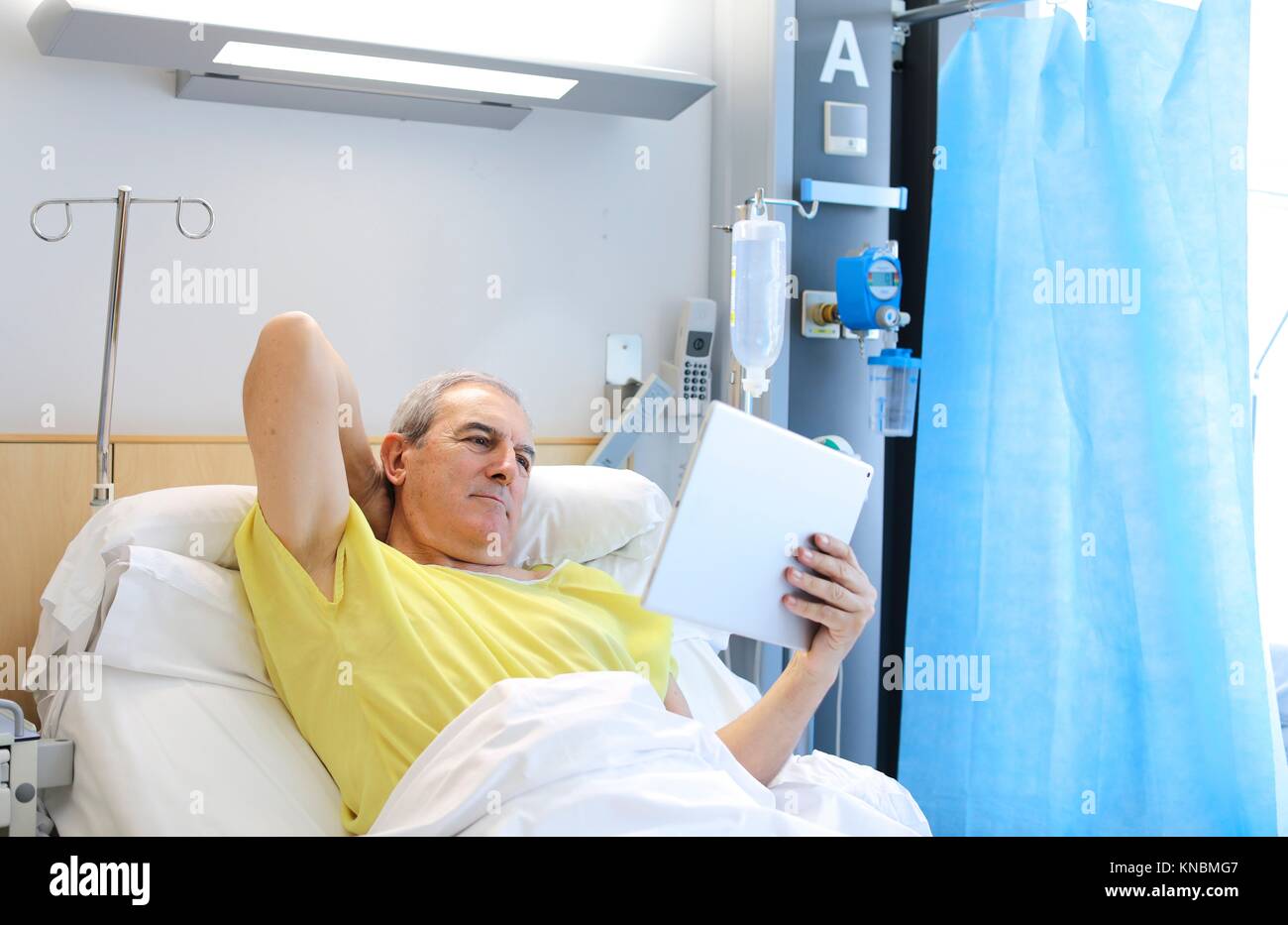 Patient in hospital room with tablet, Hospital Stock Photo - Alamy