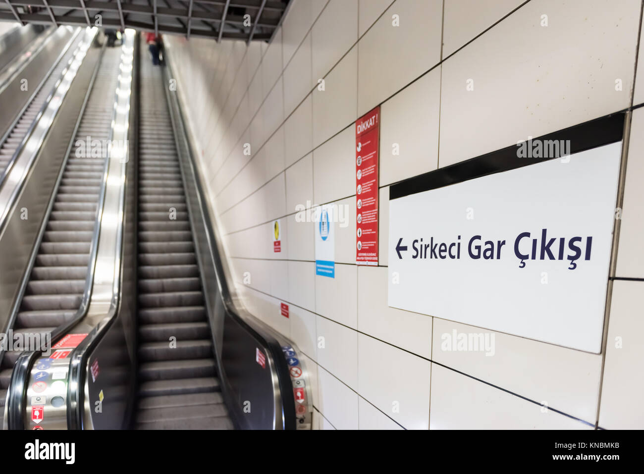 Signboard on the wall shows Exit to Sirkeci train station Istanbul ...