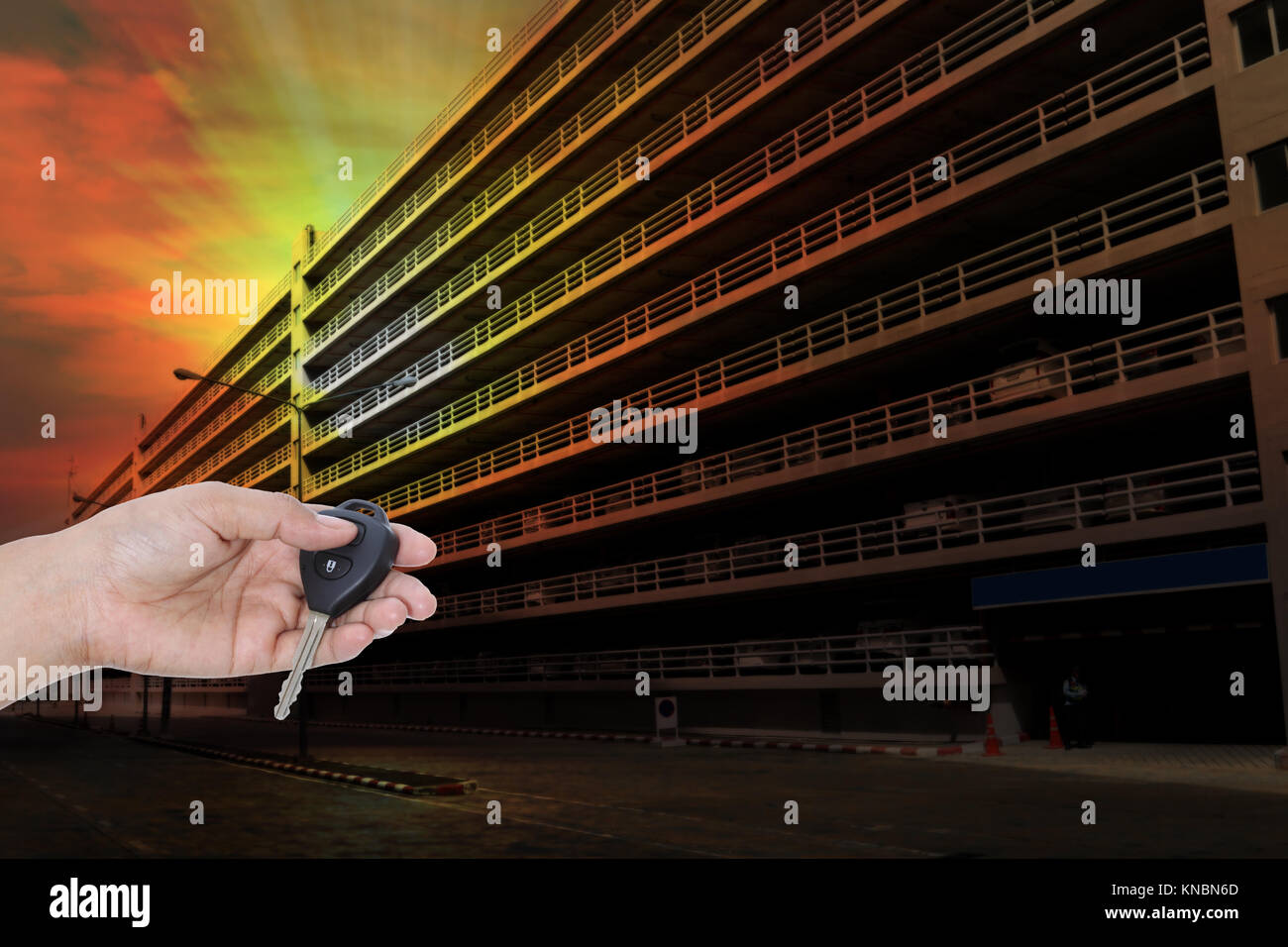 "Press unlock" female hand holding remote control car key against car ...