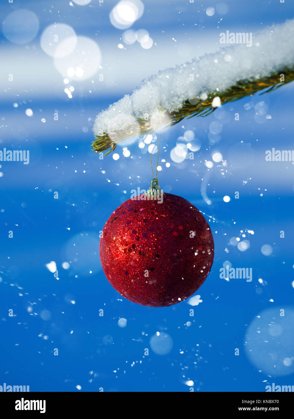 christmas tree red ball decoration with real snow Stock Photo - Alamy